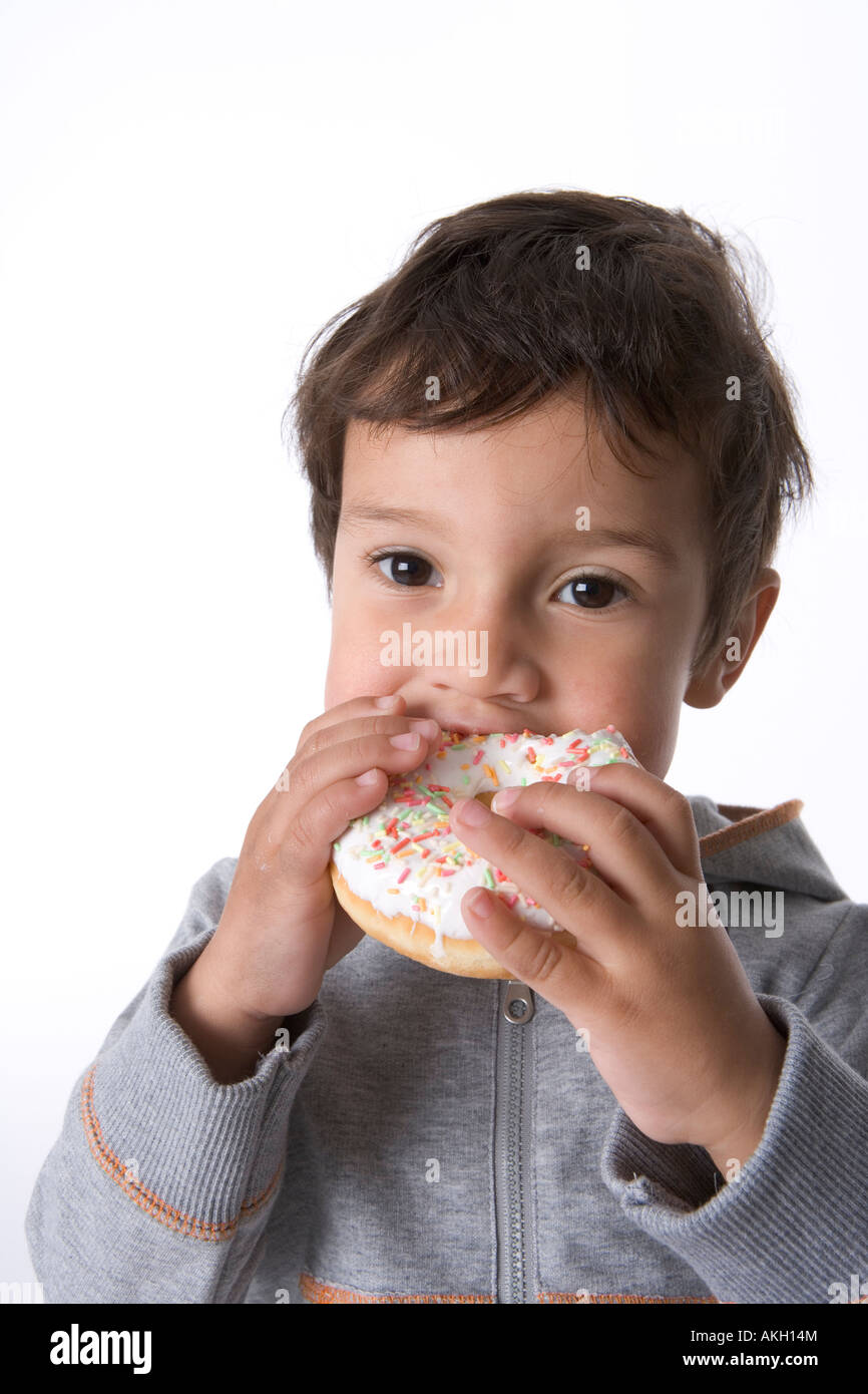 Little boy eating a donut Stock Photo - Alamy