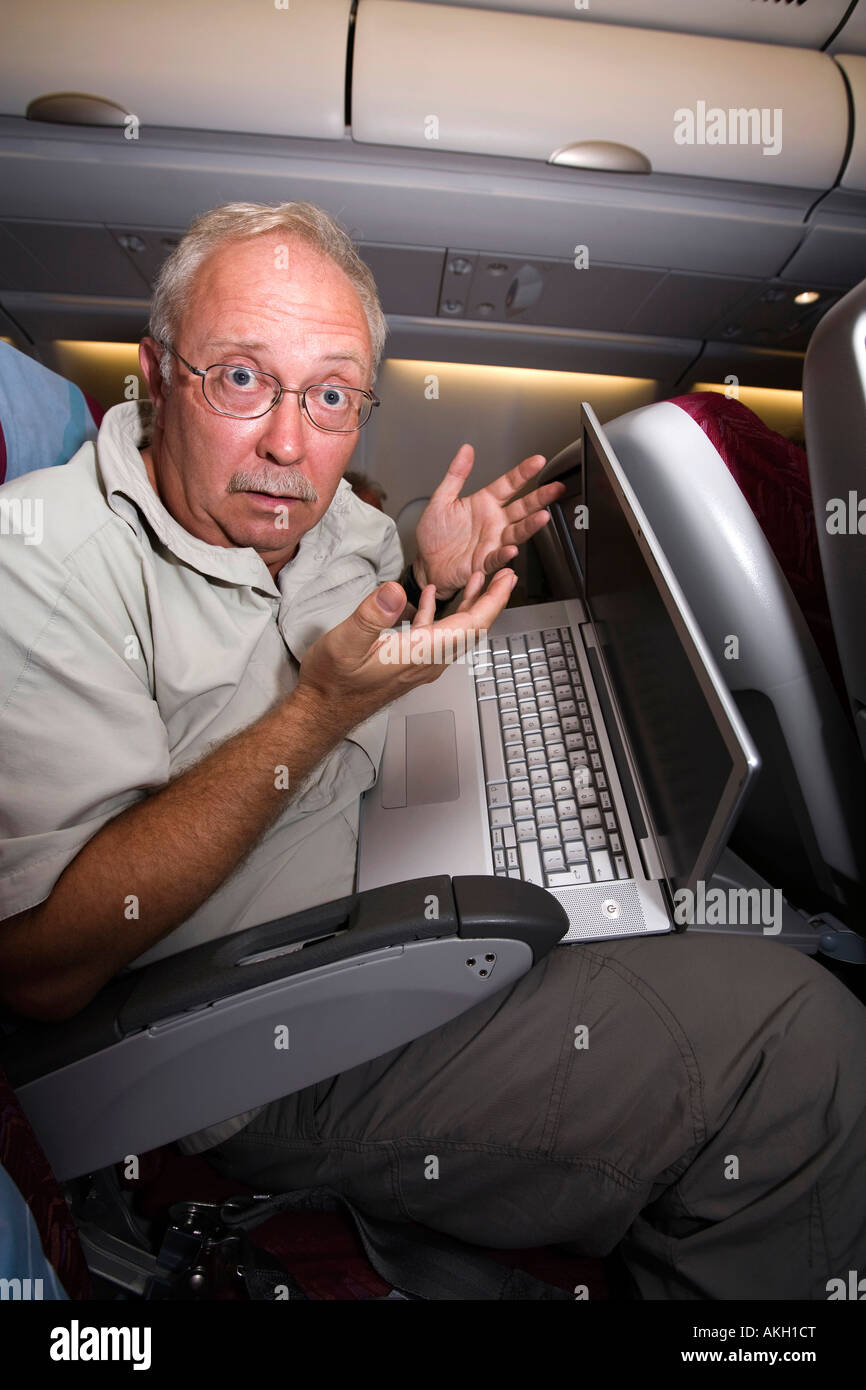 travel middle aged airline passenger squashed into economy class seat ...