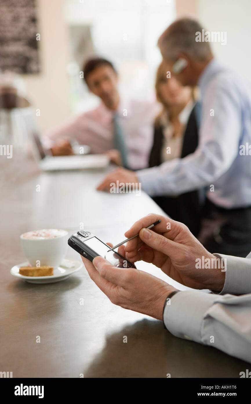Man using handheld computer at bar counter Stock Photo - Alamy