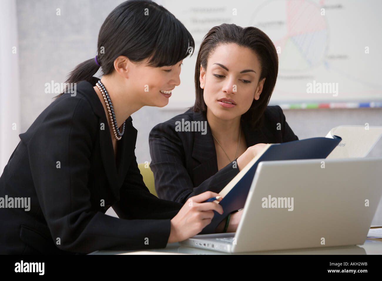Two young women working Stock Photo - Alamy
