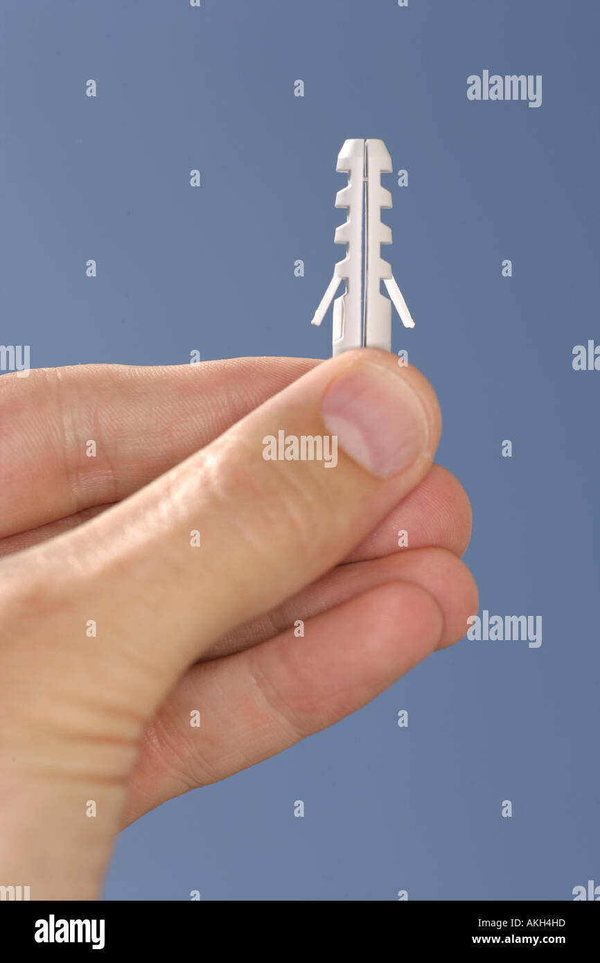 screw anchor in hand Stock Photo - Alamy
