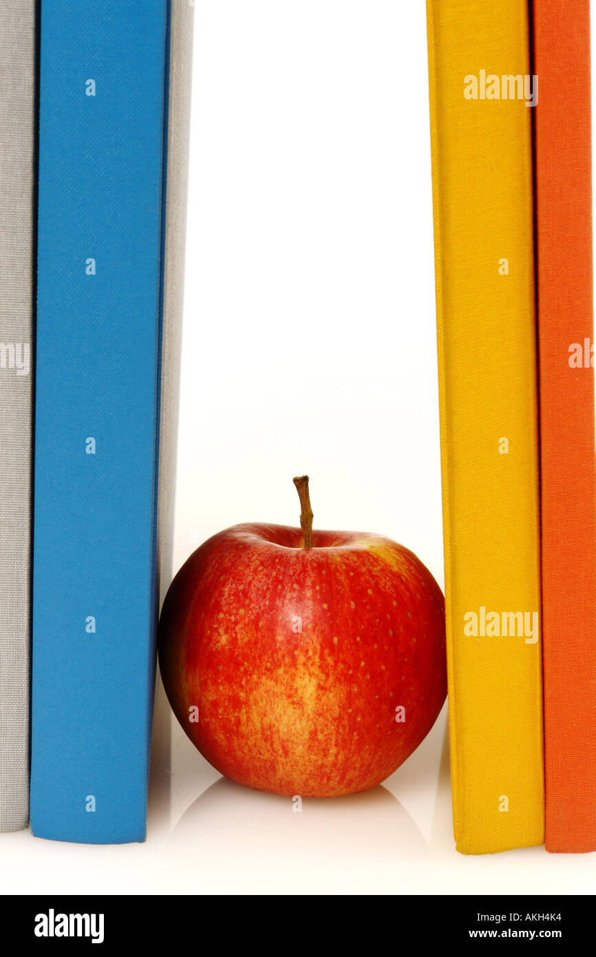 books and apple on an isolated white background Stock Photo - Alamy