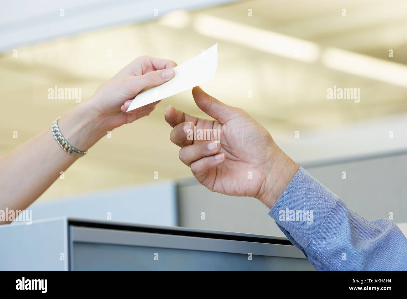 Two colleagues passing a note Stock Photo - Alamy