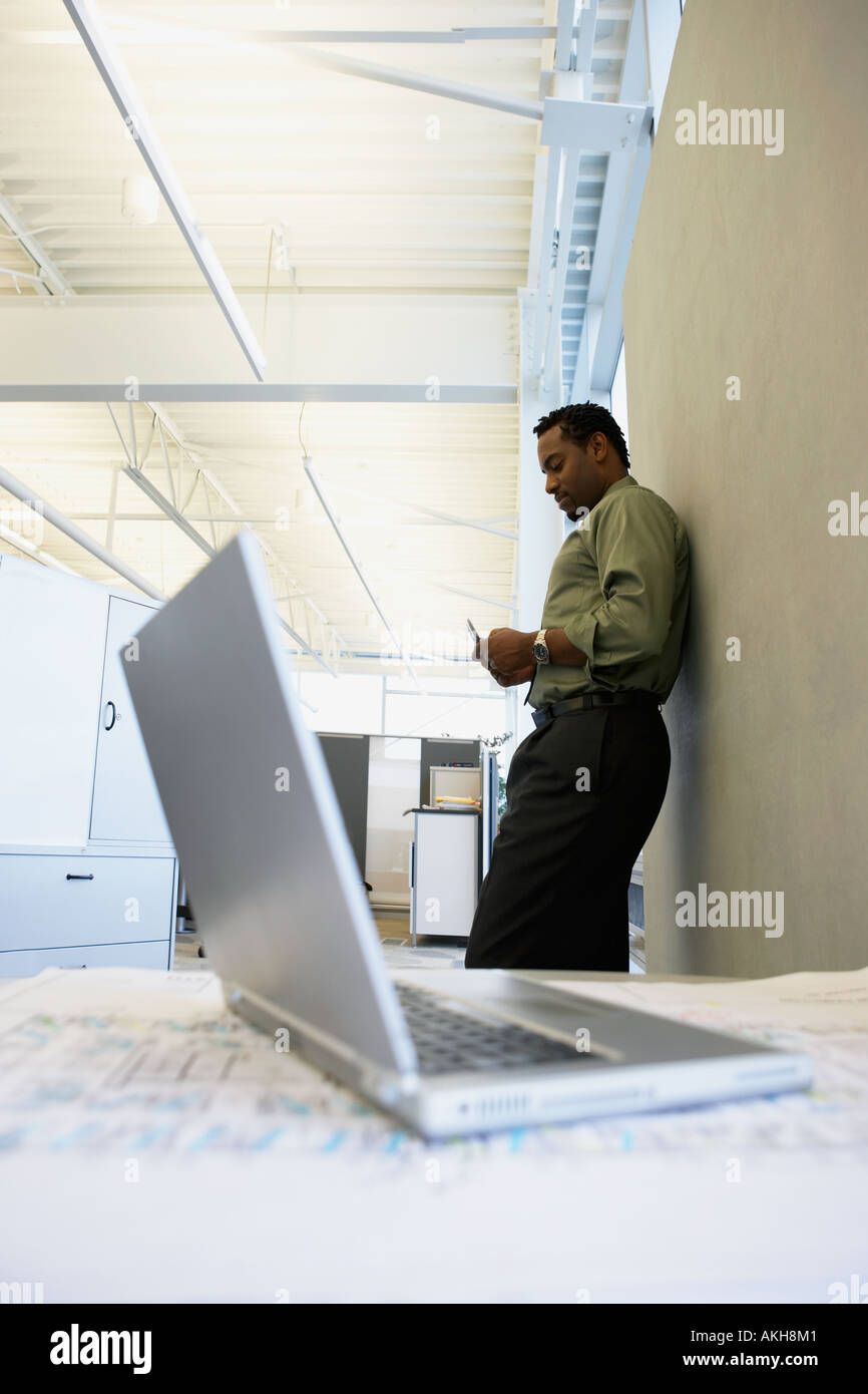 Male office worker text messaging Stock Photo - Alamy