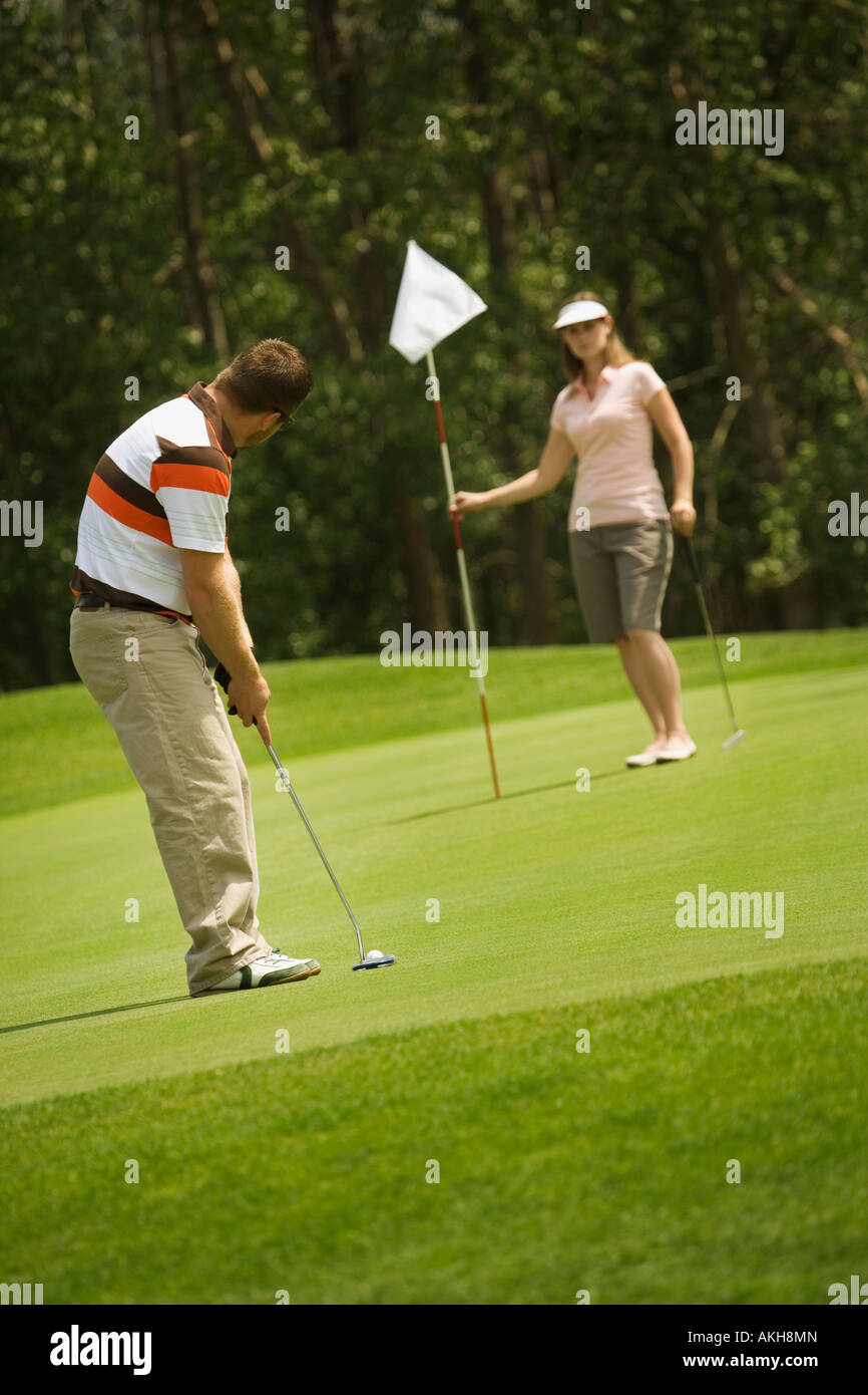 Couple golfing together Stock Photo - Alamy