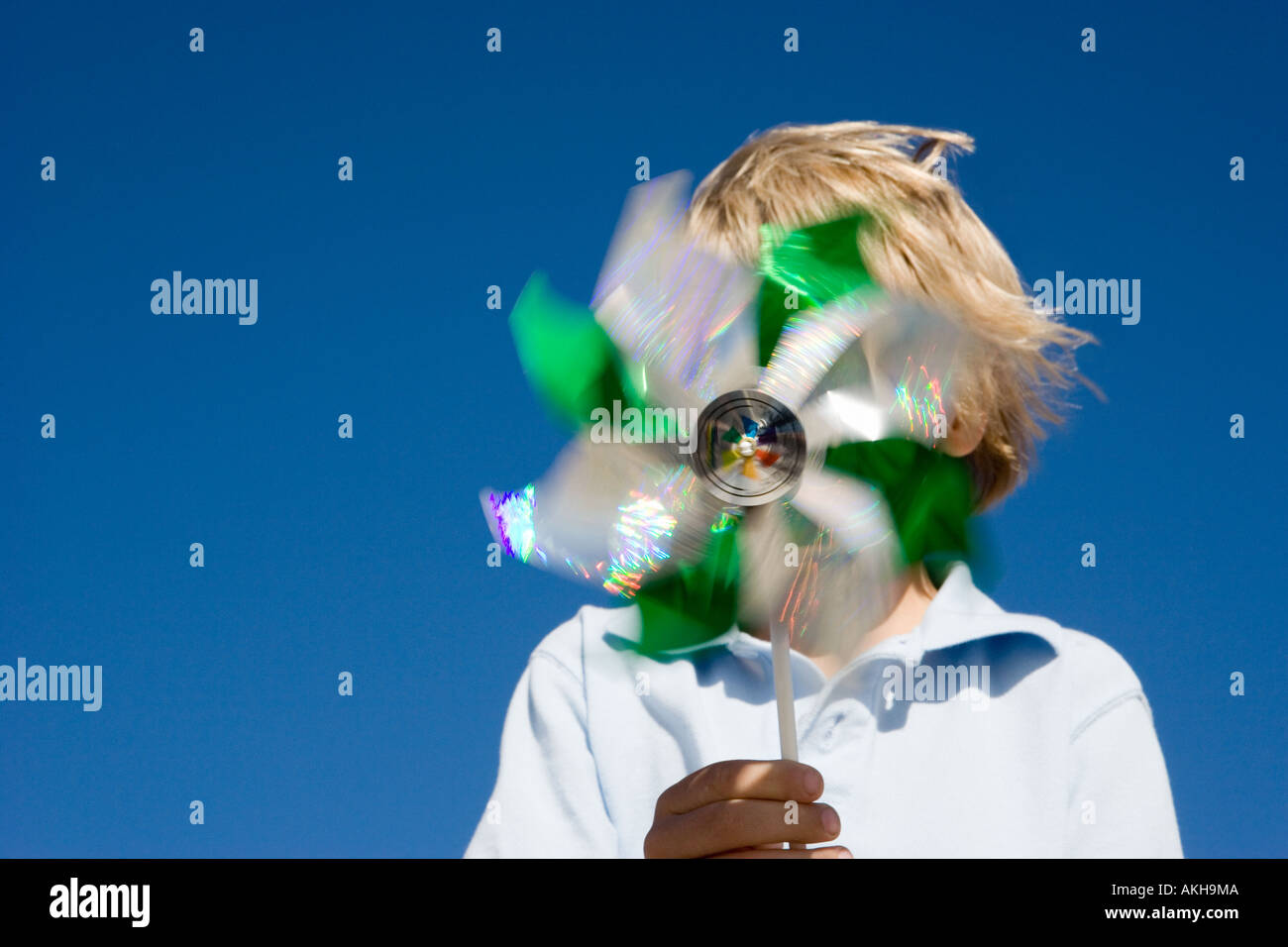 Boy holding pinwheel in front of face Stock Photo - Alamy