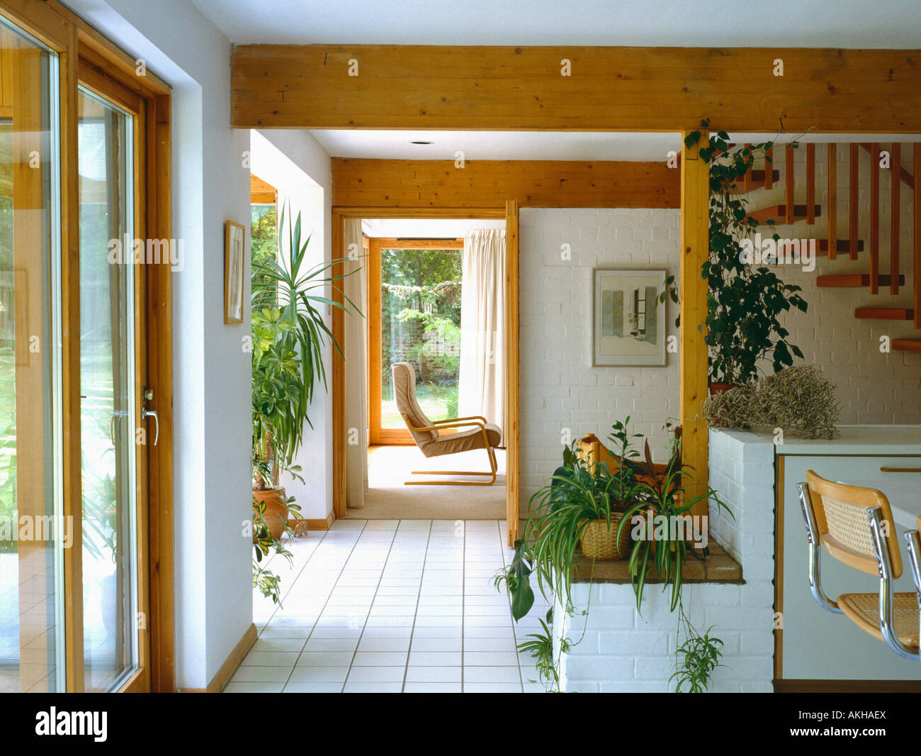 Openplan modern hall with white tiled floor and sliding doors Stock ...