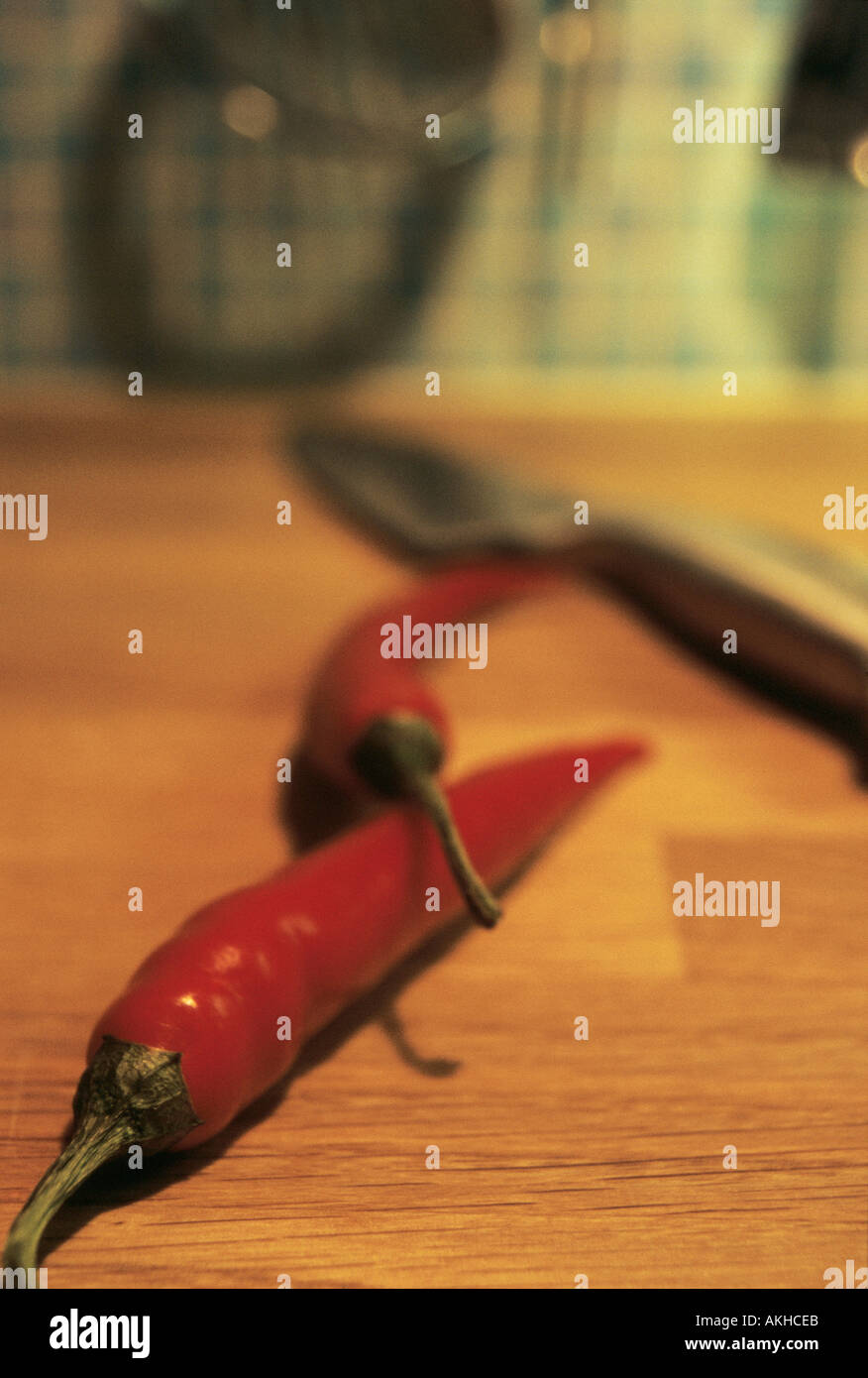 two red chili peppers in kitchen Stock Photo - Alamy