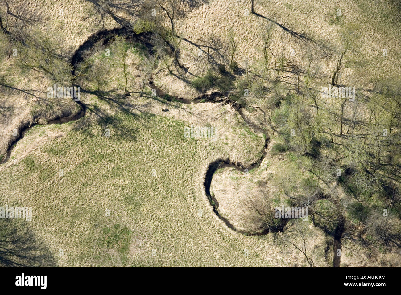 Aerial view of winding stream in rural countryside with trees Stock ...