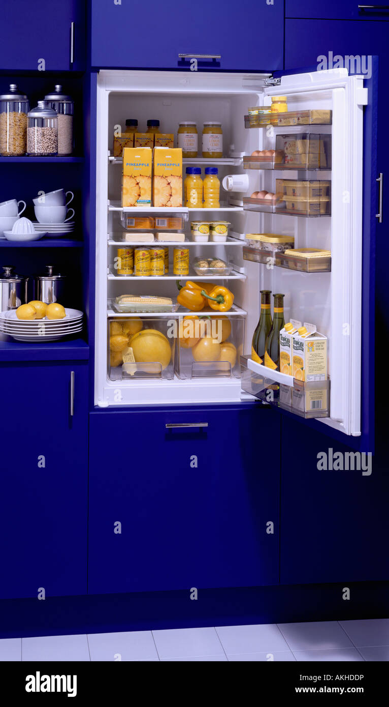 Open wall mounted fridge in blue kitchen Stock Photo - Alamy