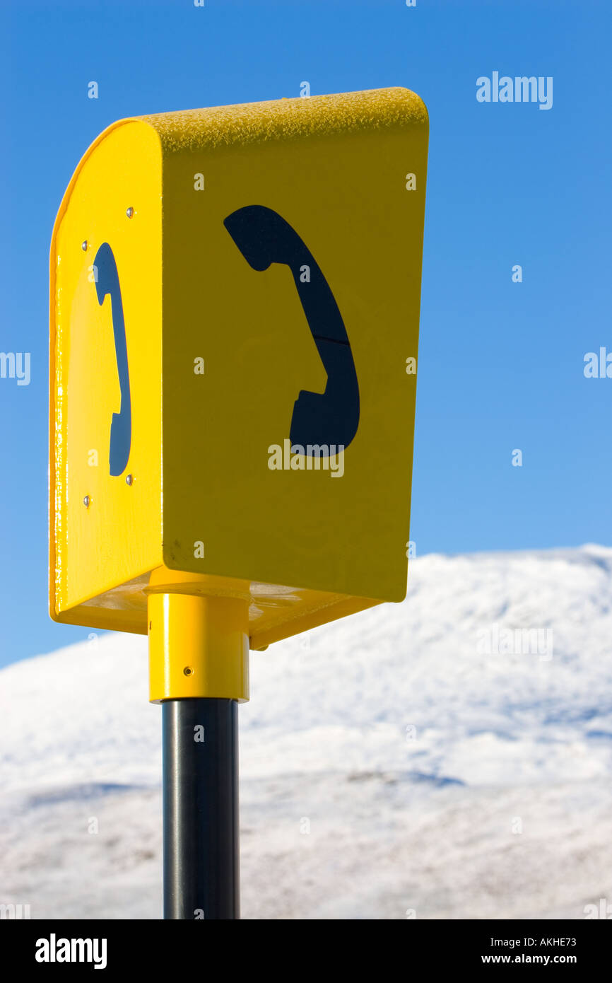 Yellow Emergency telephone mounted on black pole with soft focus ...