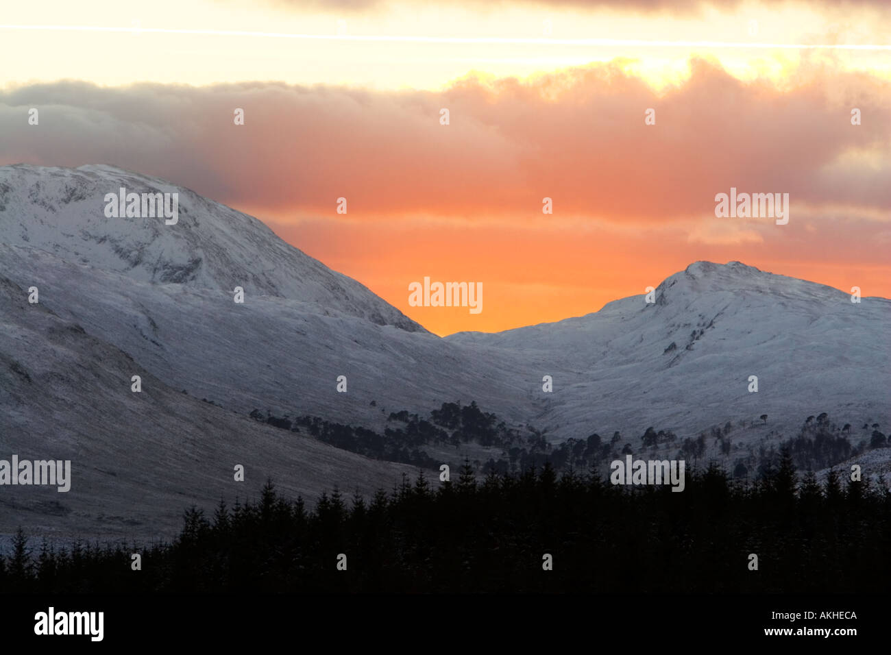 Dramatic red sky over snow covered mountains in Glencoe Scottish ...