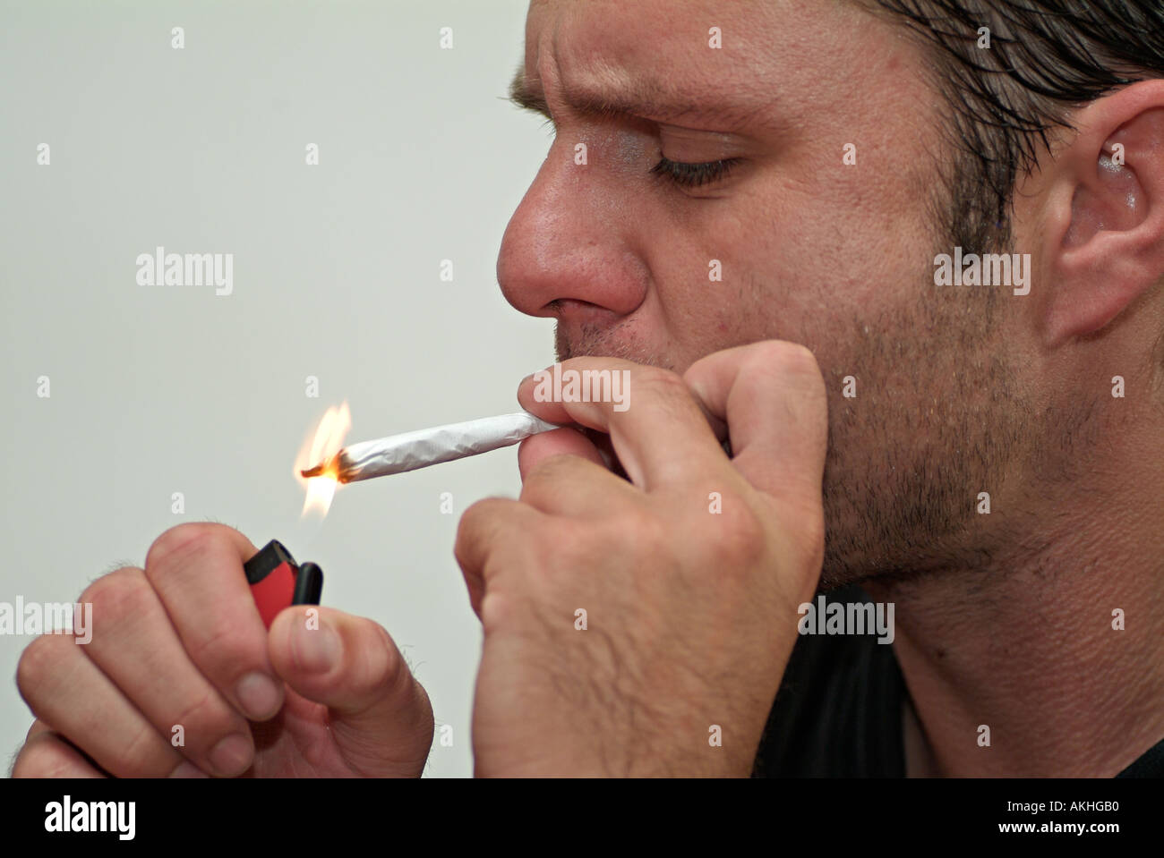 Man Lighting a Marijuana Joint Stock Photo - Alamy
