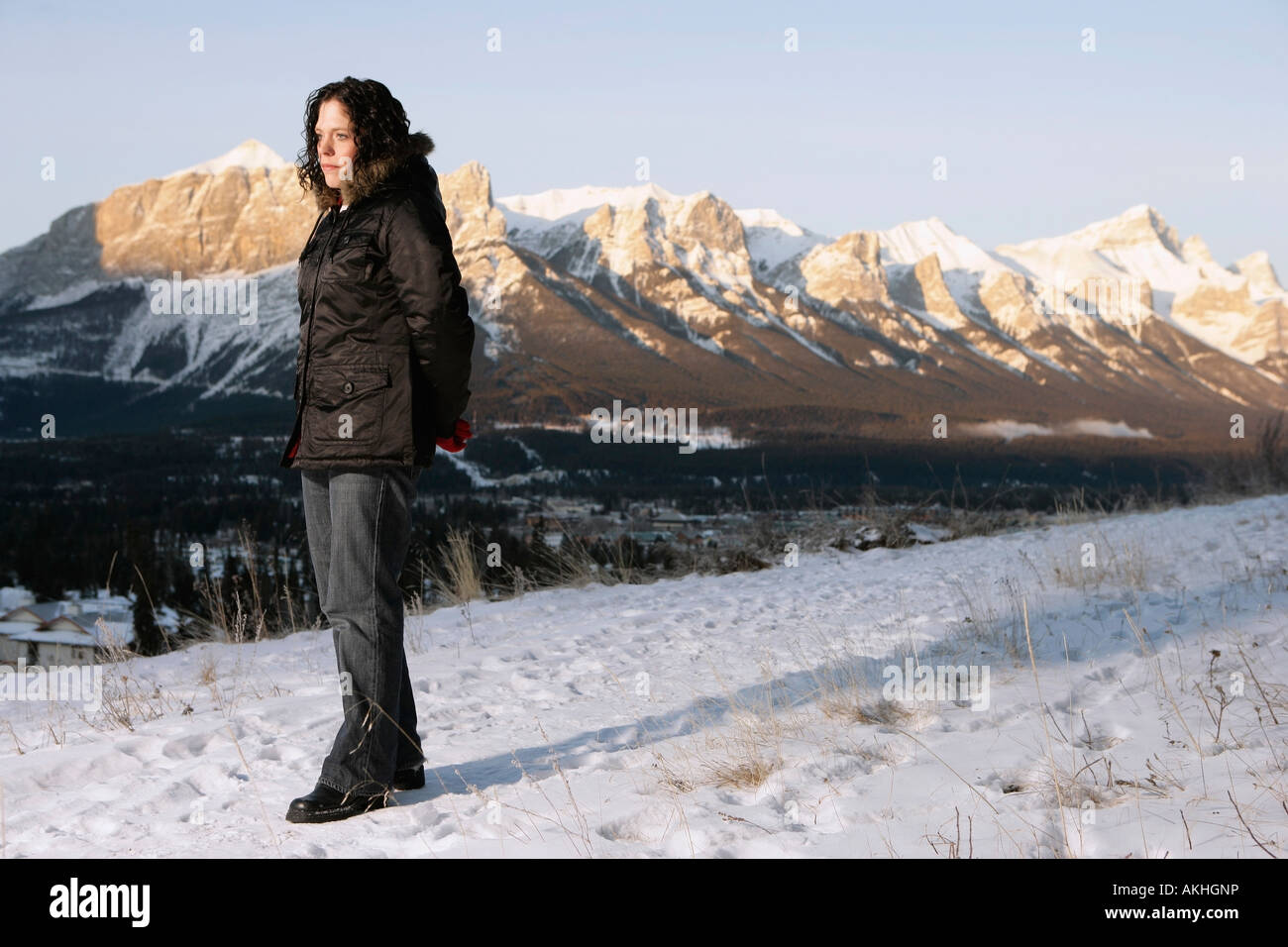 Side view of woman standing on snow Stock Photo - Alamy