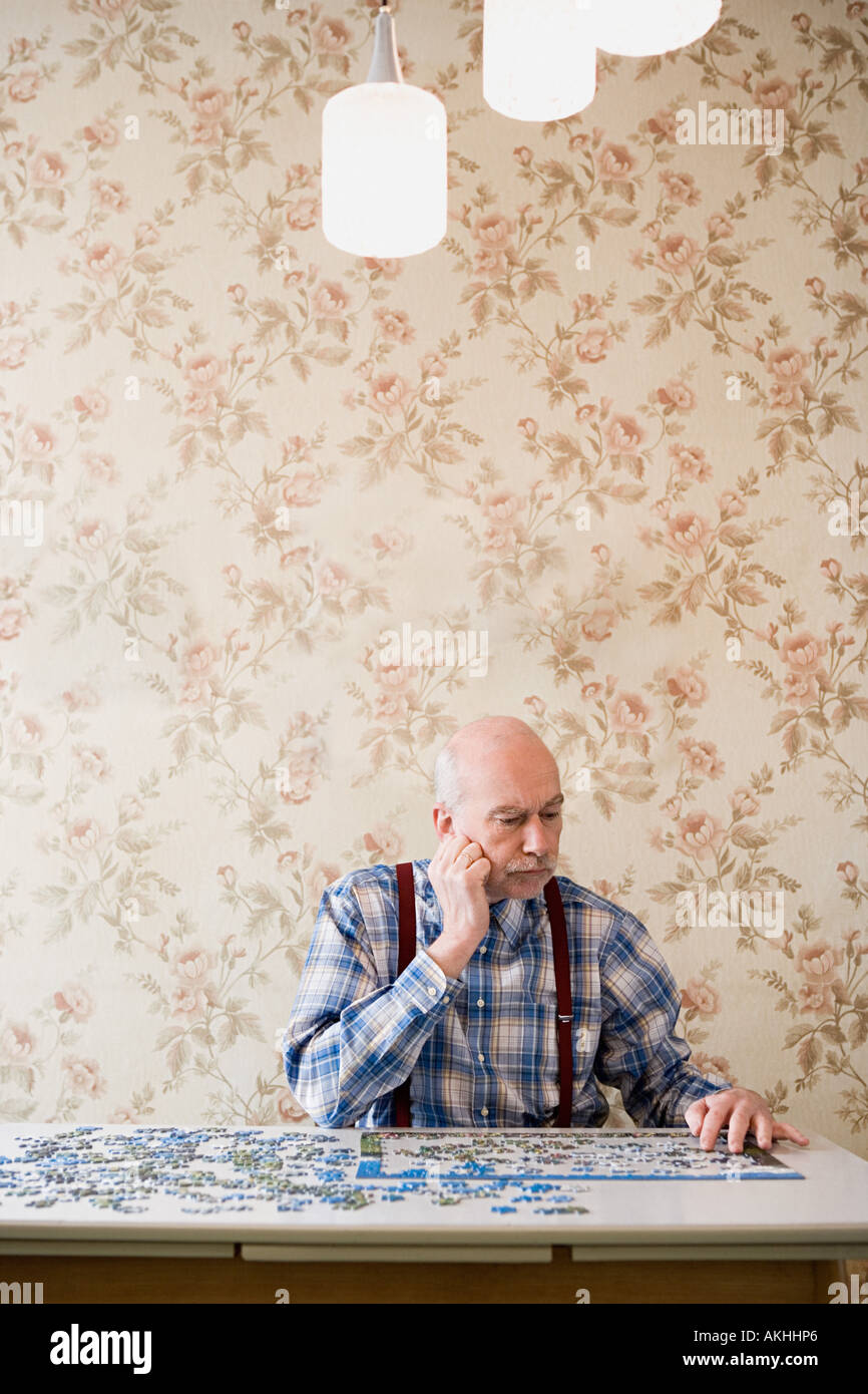 Man with a jigsaw puzzle Stock Photo - Alamy