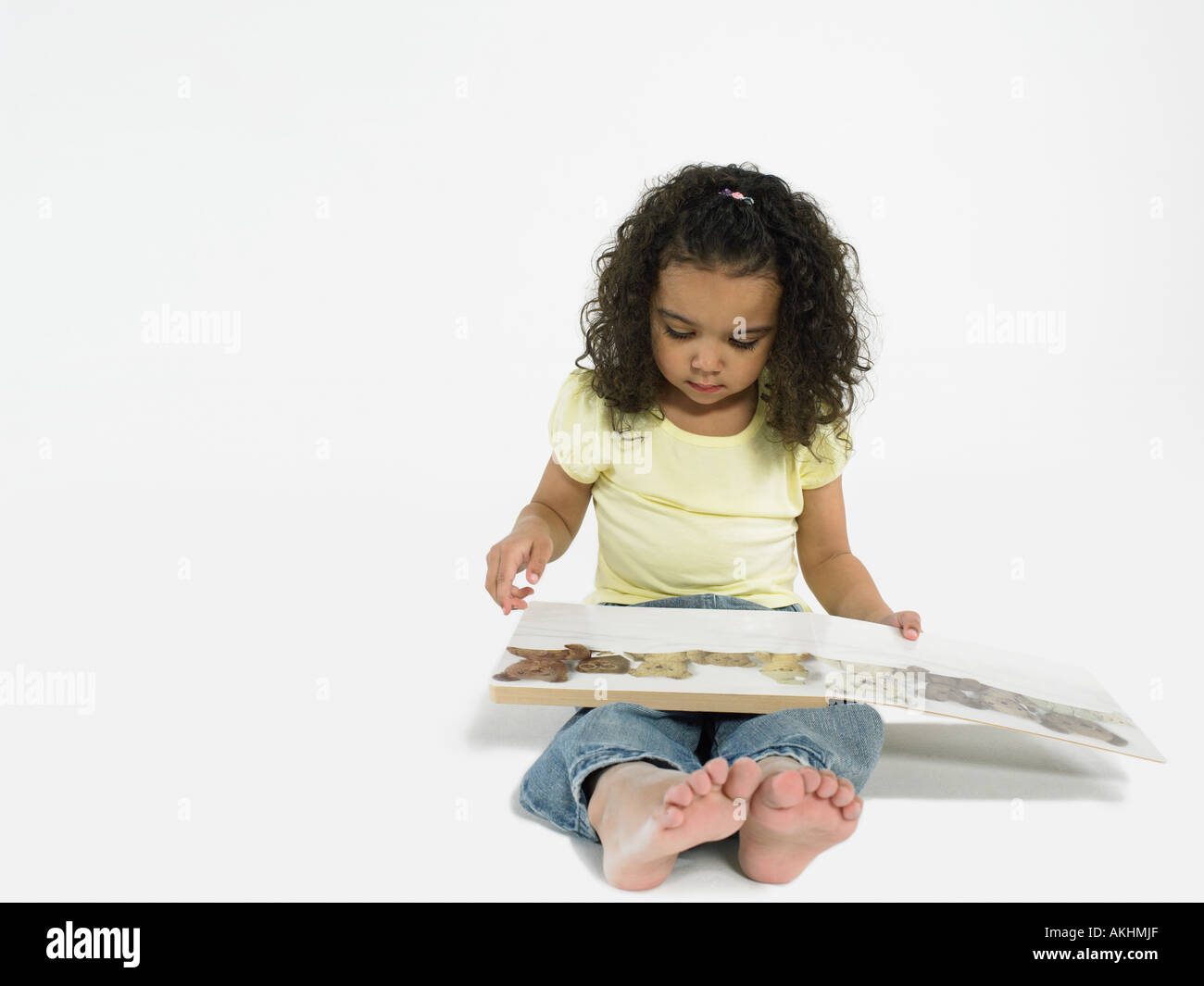Girl reading a storybook Stock Photo - Alamy
