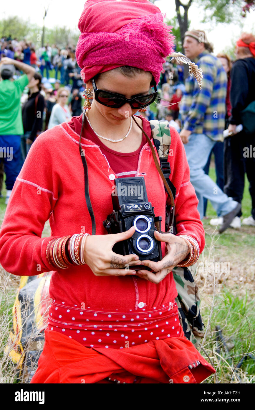 Woman photographing with Yashica twin-lens reflex camera. MayDay Parade ...