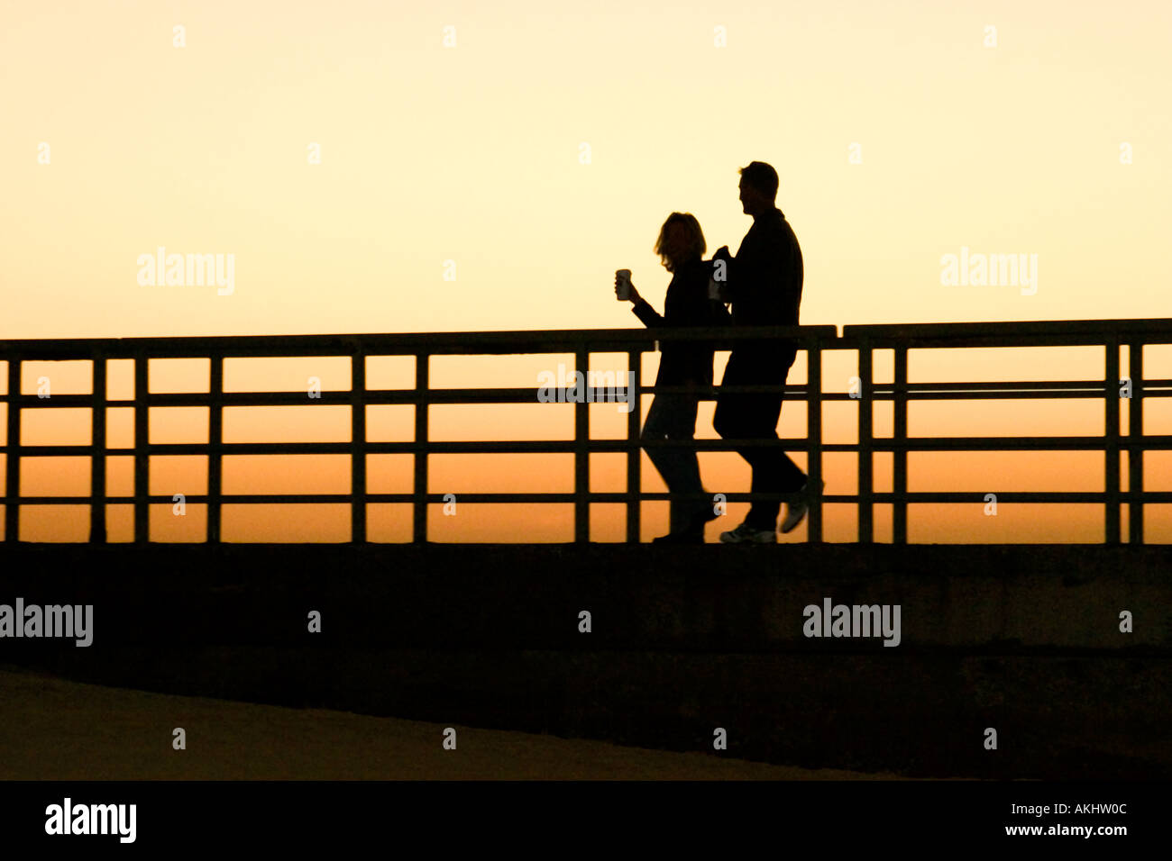 Woman walks along boardwalk hi-res stock photography and images - Alamy