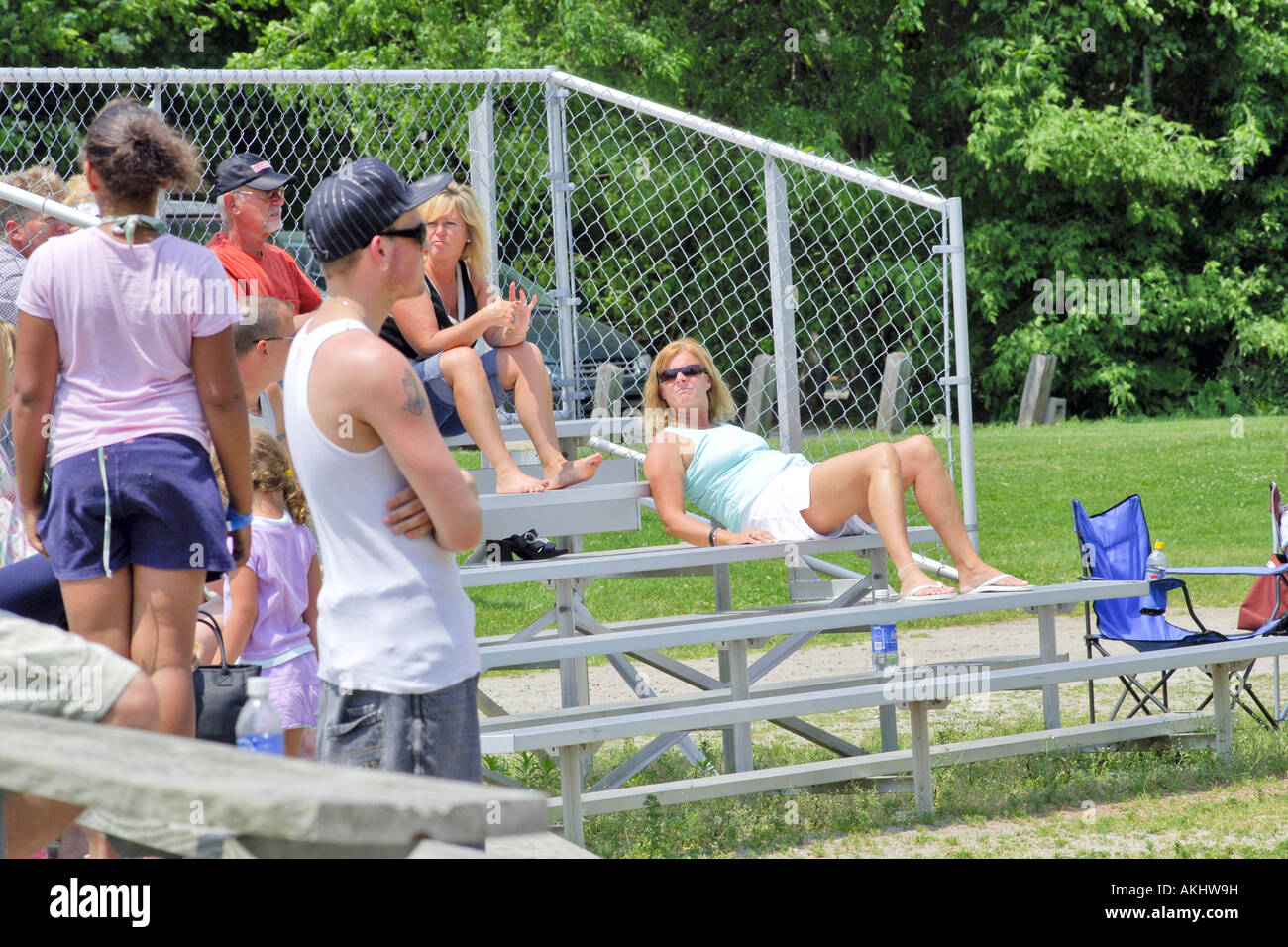 Proud parents watch their children at a school softball game Stock ...