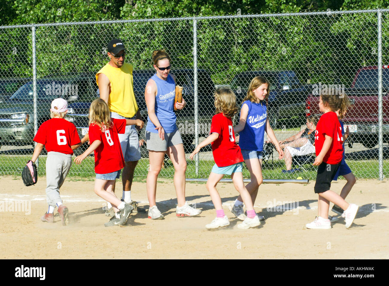 2nd grade school childrens finish softball practice with a low five ...