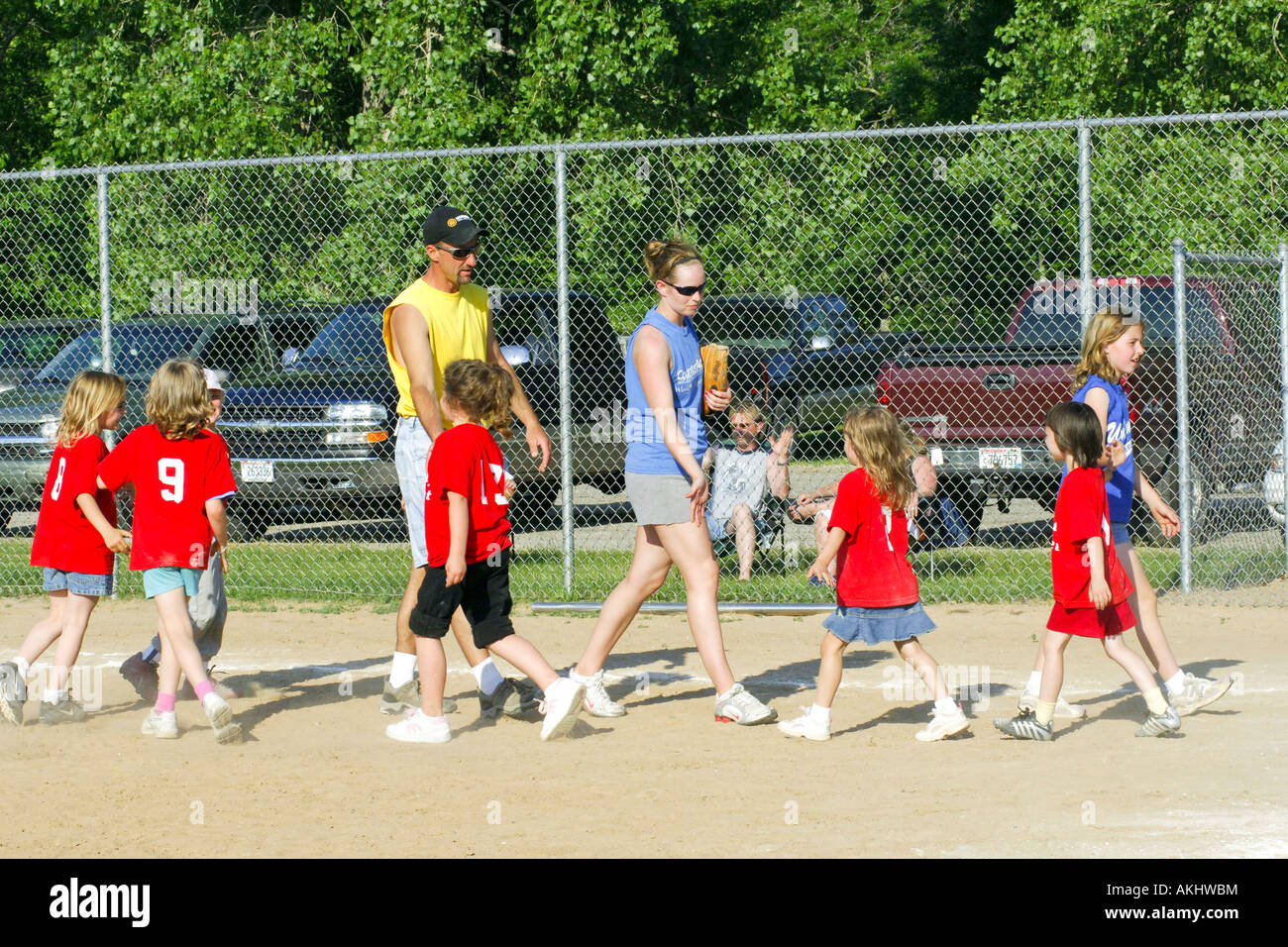 2nd grade school childrens finish softball practice with a low five ...