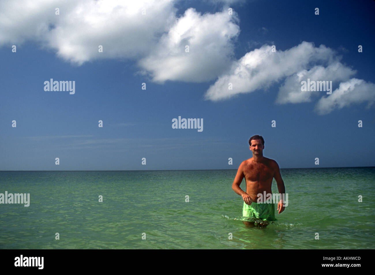Man Wading in Tropical Water Stock Photo - Alamy