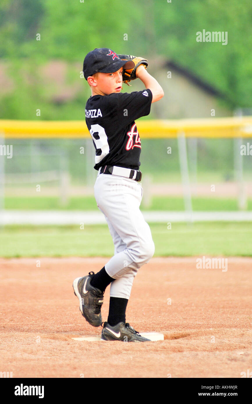 Determined teenage male softball pitcher playing for the Michigan ...