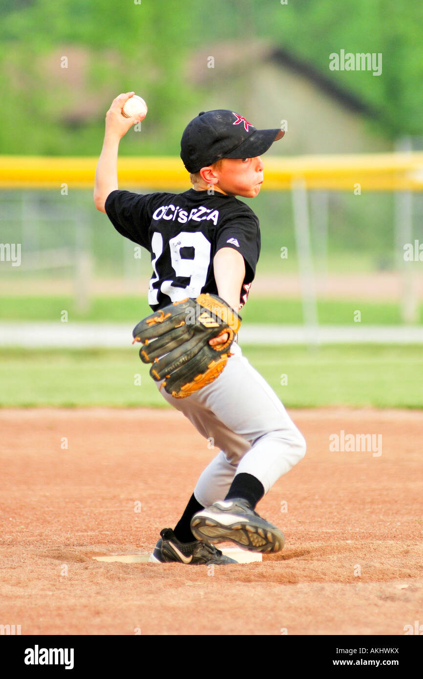 Determined teenage male softball pitcher playing for the Michigan ...