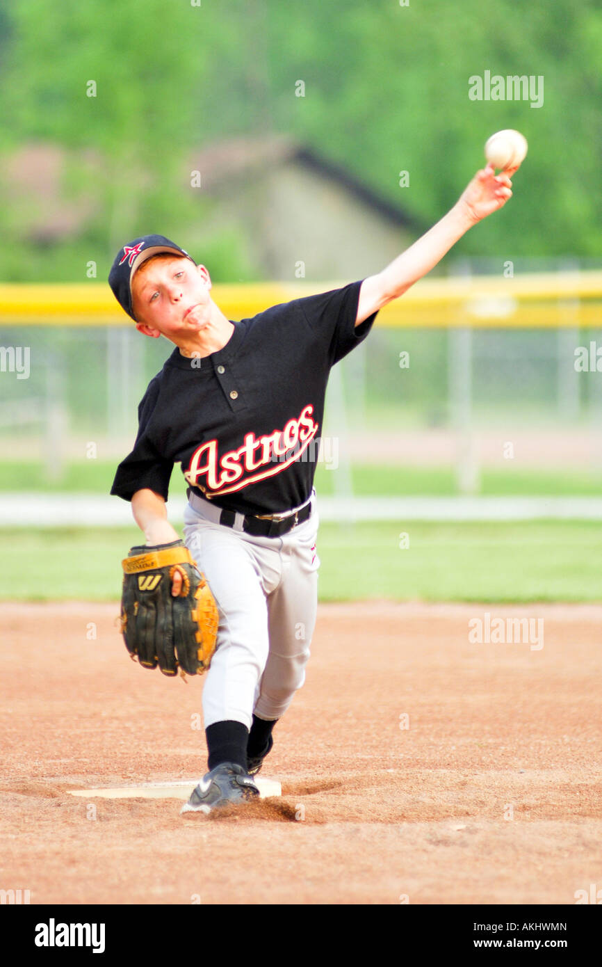 Determined teenage male softball pitcher playing for the Michigan ...