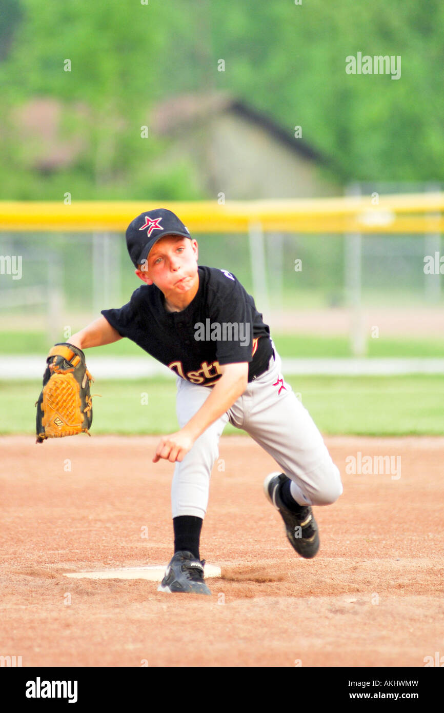 Determined teenage male softball pitcher playing for the Michigan ...