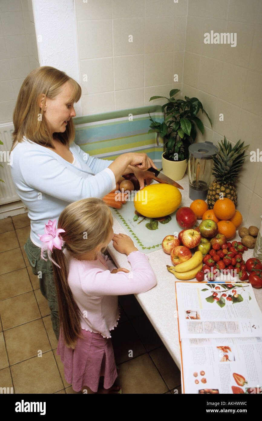 Mother and Daughter In Kitchen With Fruit Stock Photo - Alamy