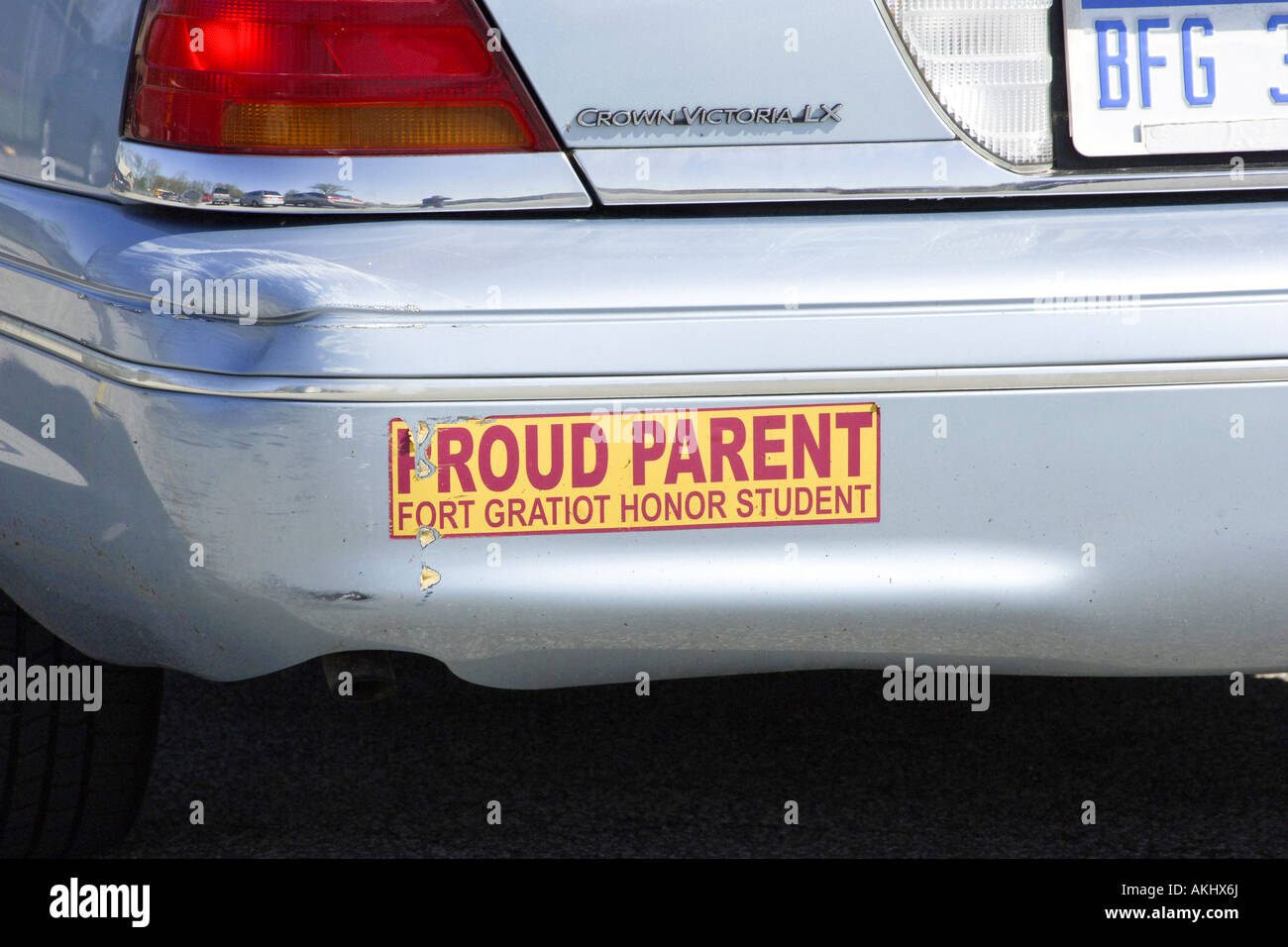 Bumper sticker on the rea of a vehicle reading Proud Parent in red and ...
