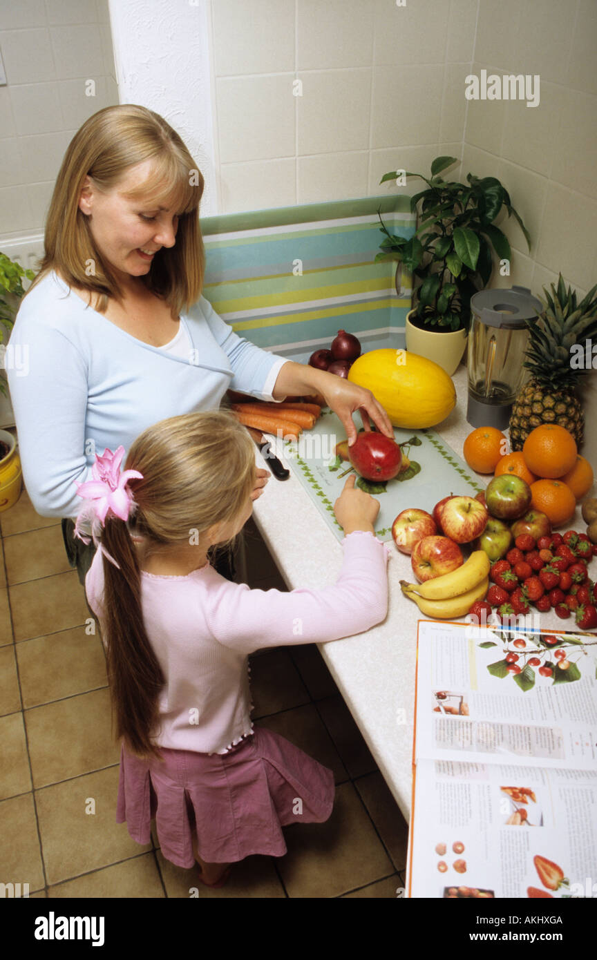 Mother And Daughter With Fruit Stock Photo - Alamy