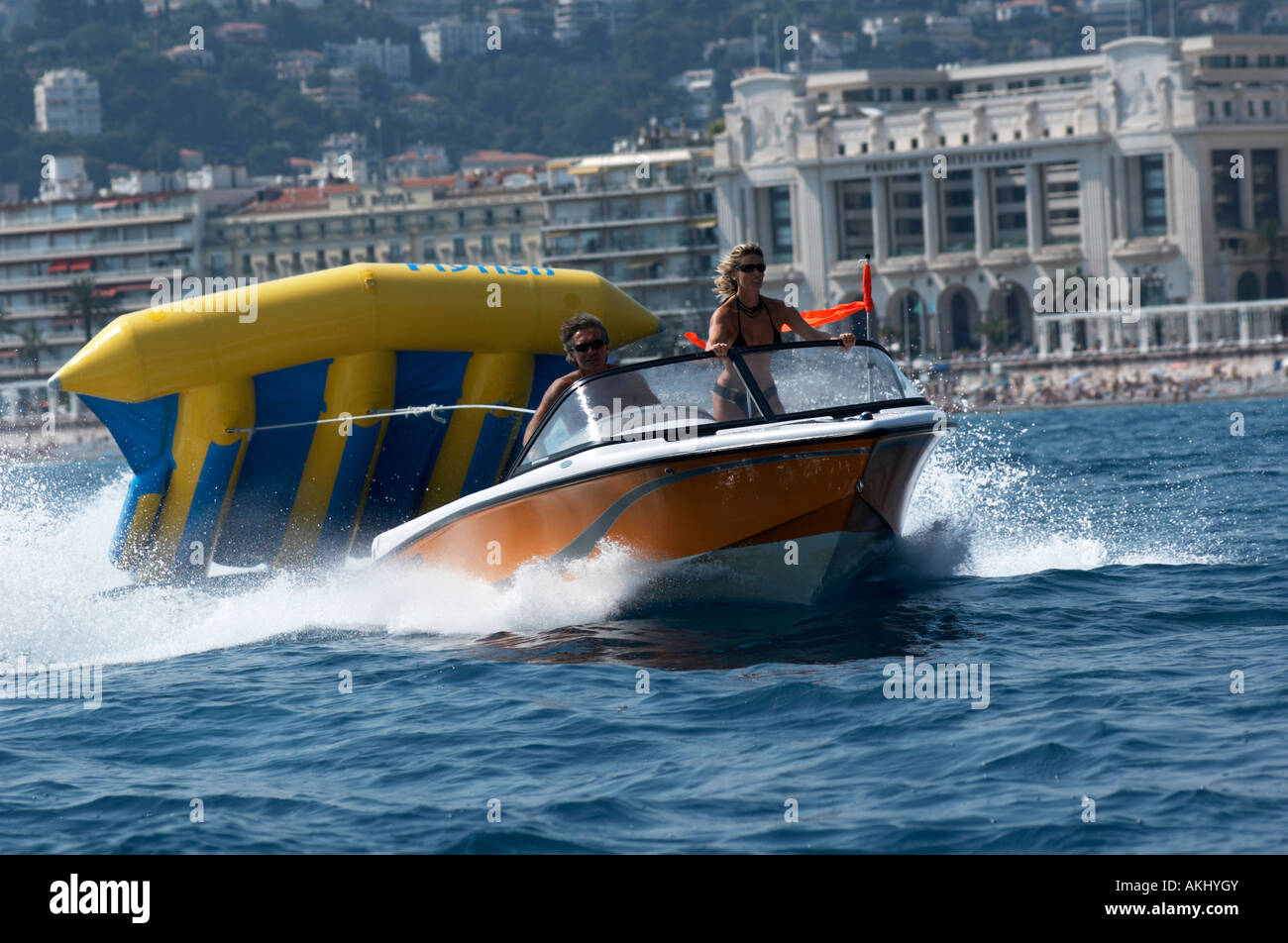 A speed boat pulling a banana boat in the Mediterranean at Nice, Cote d ...