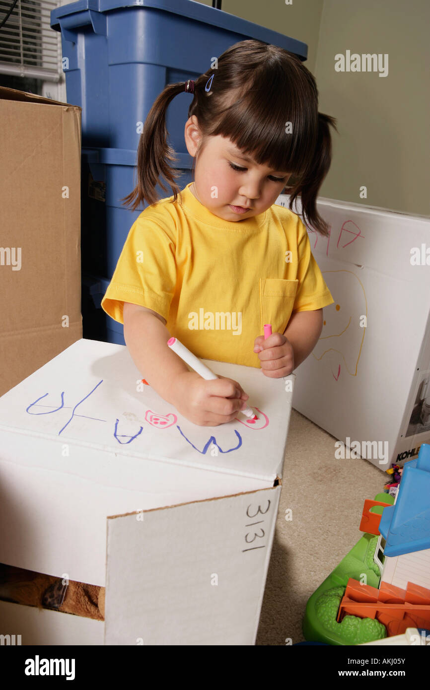 Girl writing on box Stock Photo - Alamy