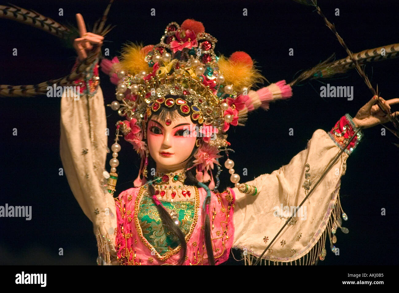 Female Puppet with beautiful feather headress in a traditional Chinese ...