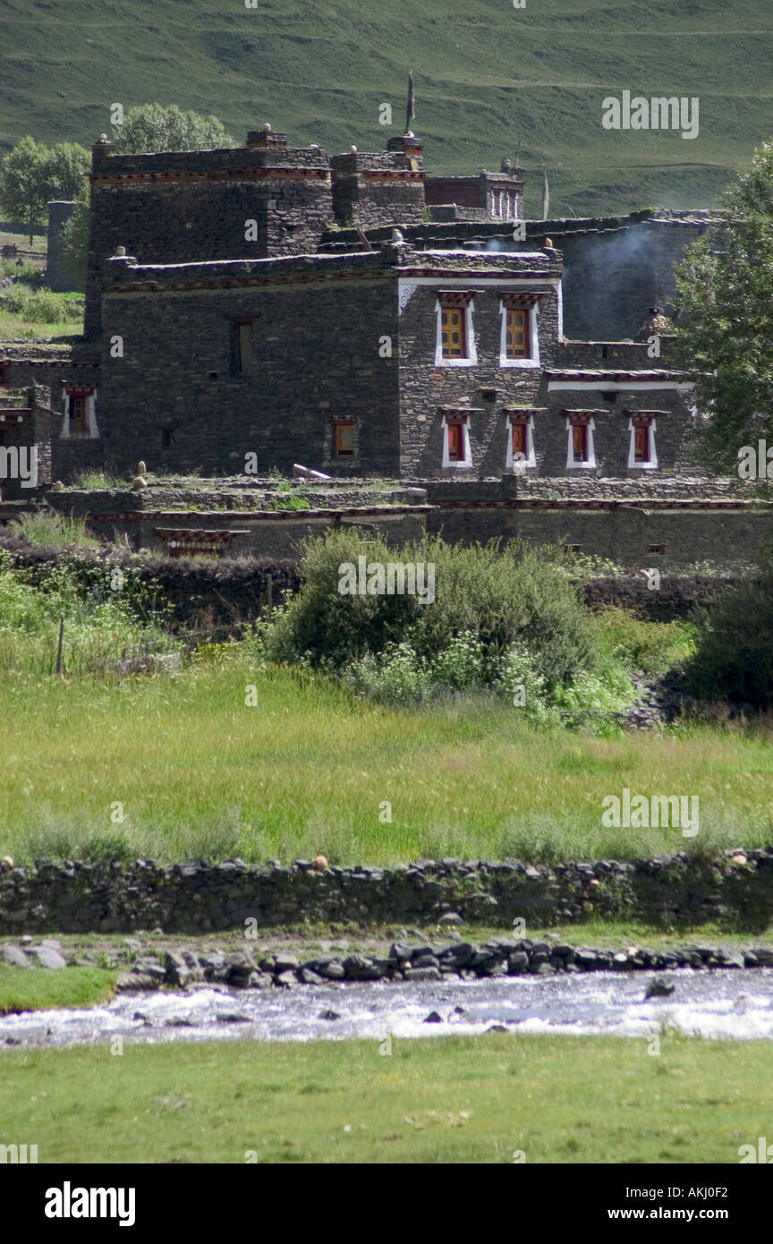 Traditional Tibetan style stone houses river in the highlands of Kham ...
