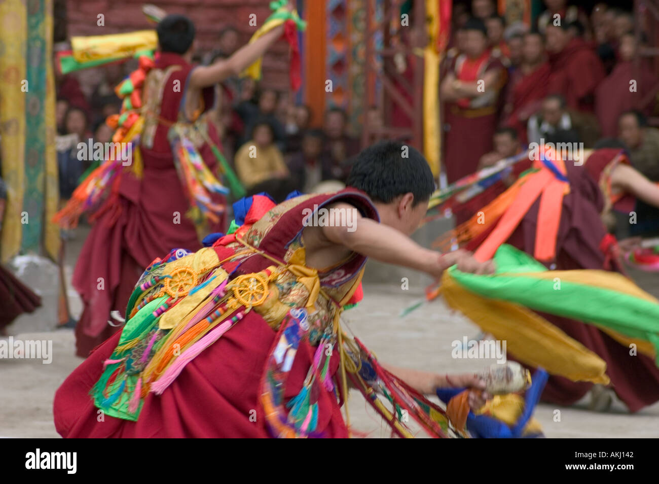Monks dance with ribbons representing deity powers at the Monlam Chenmo ...