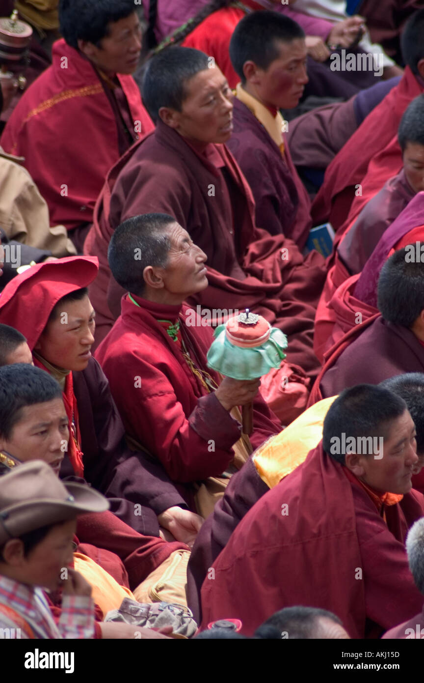 Nun with praye wheel at the Monlam Chenmo ritual dances Katok Dorjeden ...