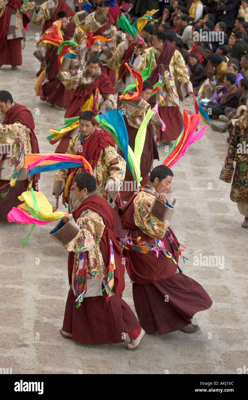 Monks dance with ribbons representing deity powers at the Monlam Chenmo ...