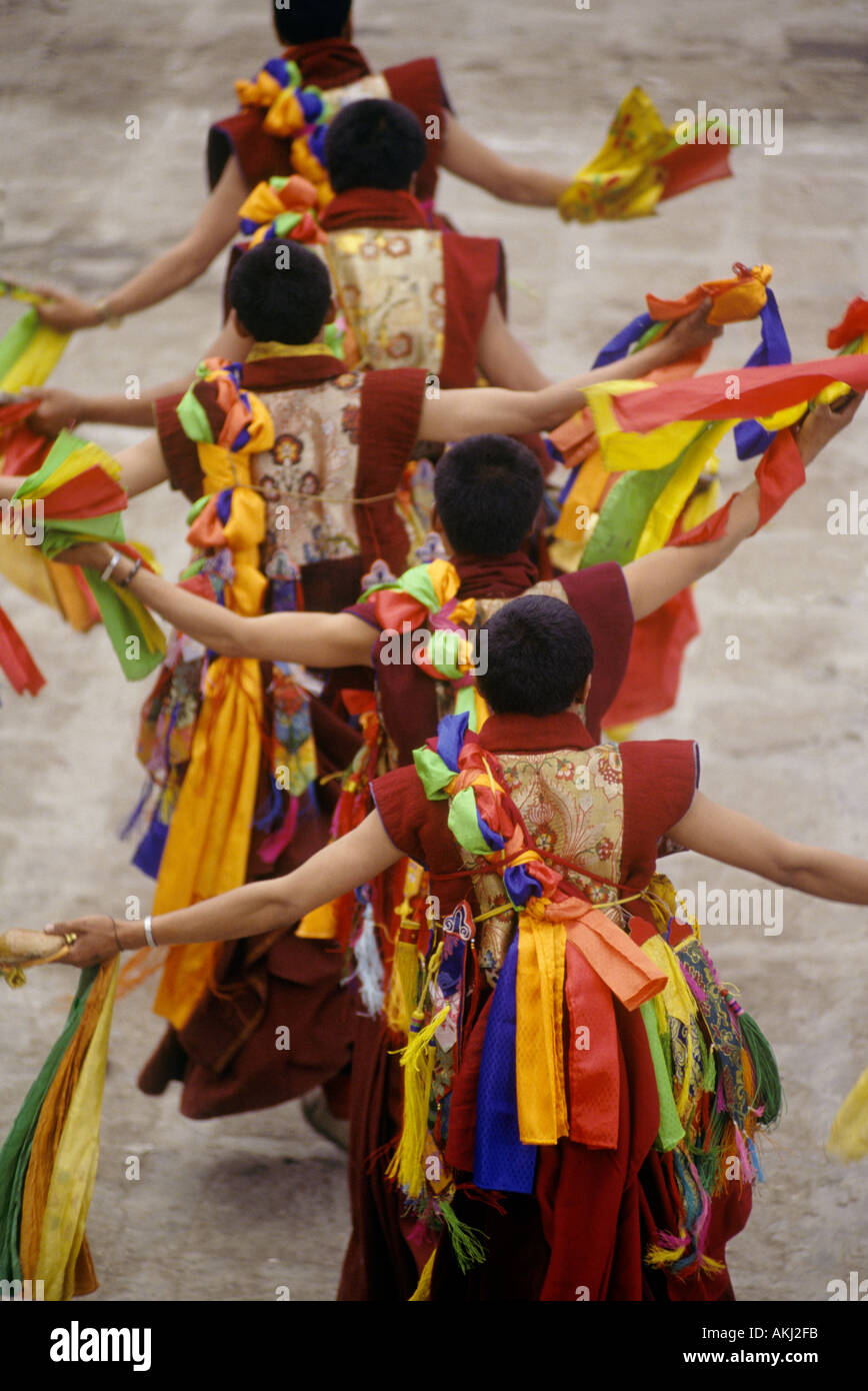 Monks dance with ribbons representing deity powers at the Monlam Chenmo ...
