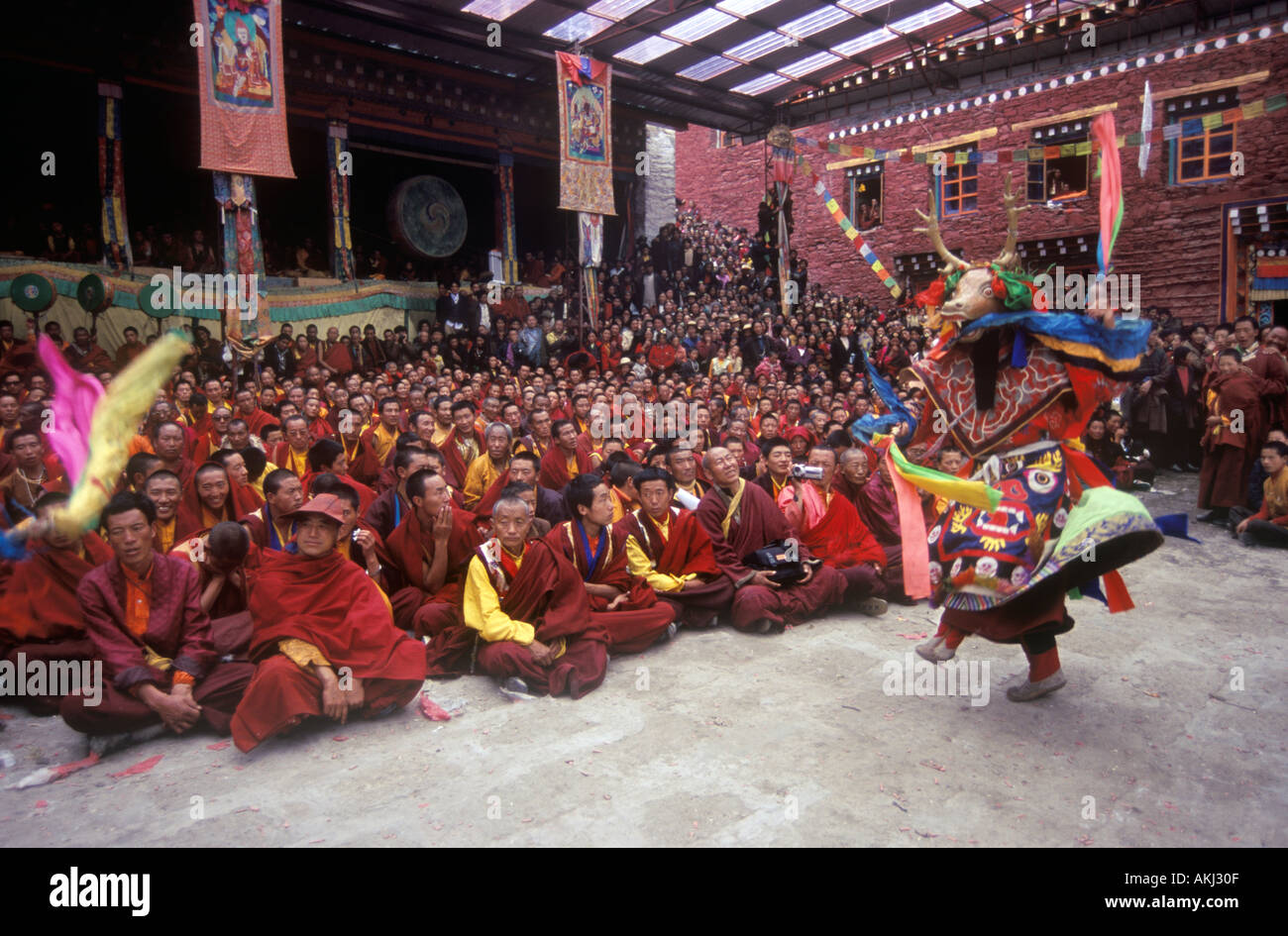 Masked stag dancer representing the animal world at the Monlam Chenmo ...