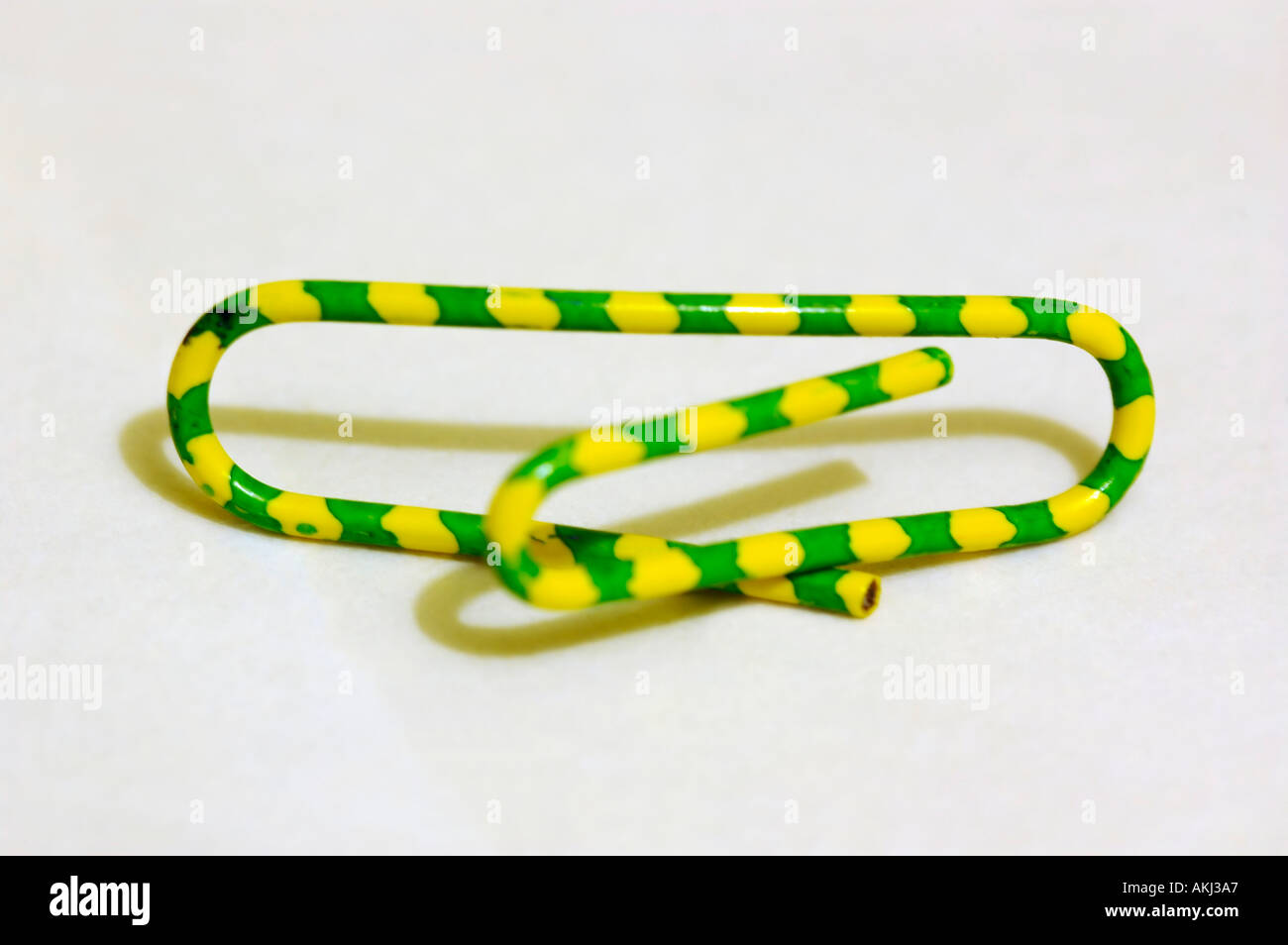 Green and Yellow coloured paperclip Stock Photo - Alamy