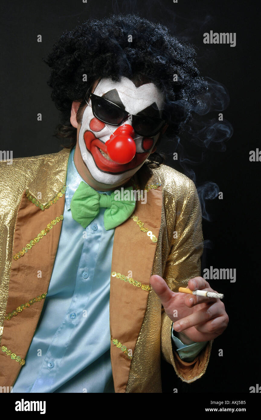 Portrait of a clown smoking and making smoke rings in the air Stock ...