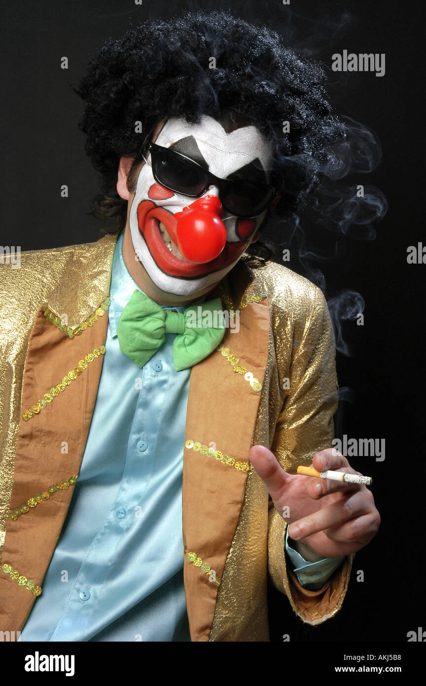 Portrait of a clown smoking and making smoke rings in the air Stock ...