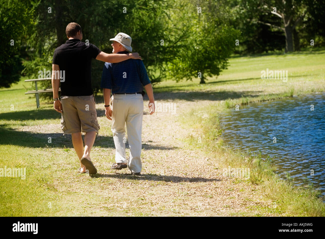 Two men walking in the park Stock Photo - Alamy
