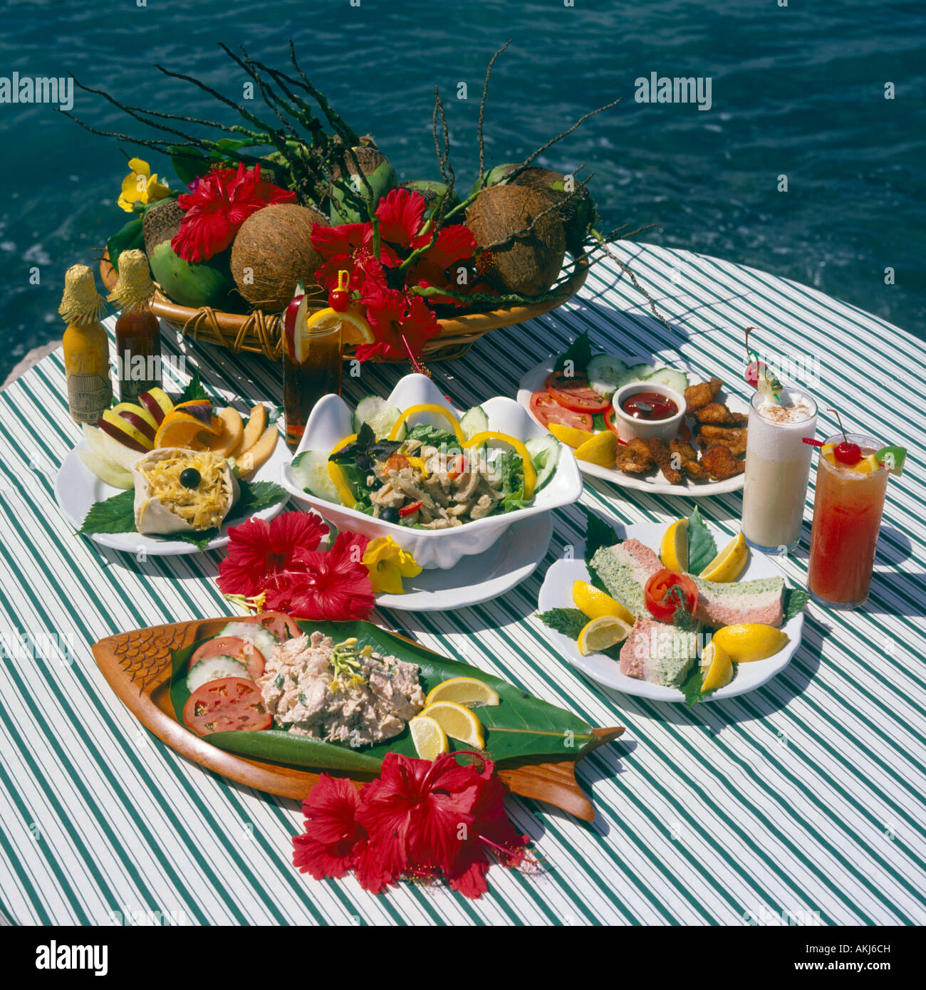 Table laid with typical colourful local tropical food salad & drinks on ...
