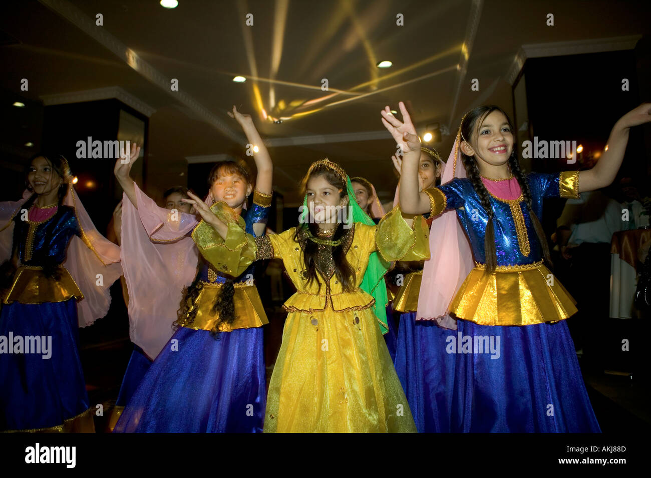 Young girls in traditional costume performing ethnic dance in Tahskent ...