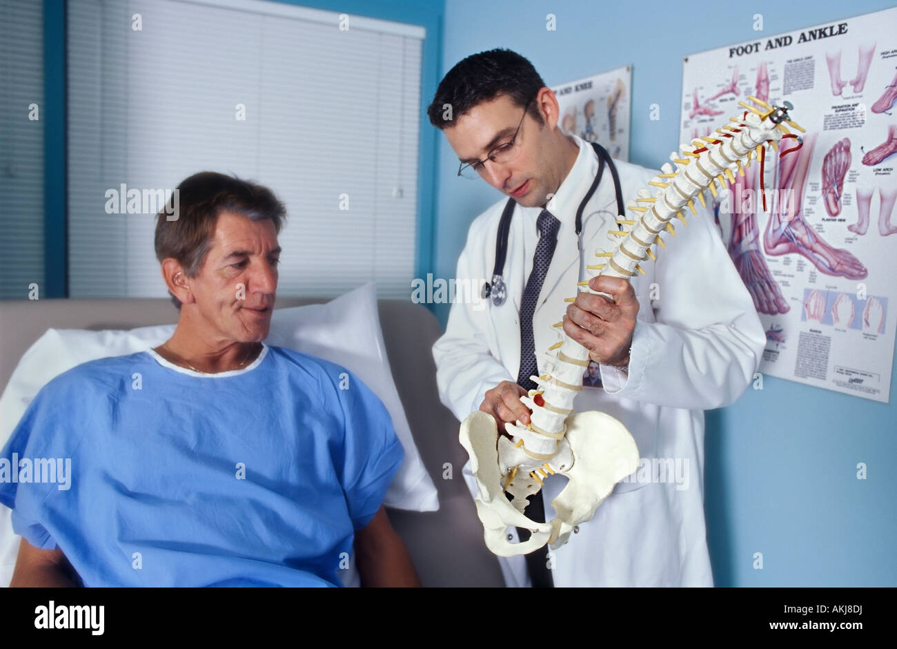 Doctor advising a patient with a 3 D spine section skeleton Stock Photo ...
