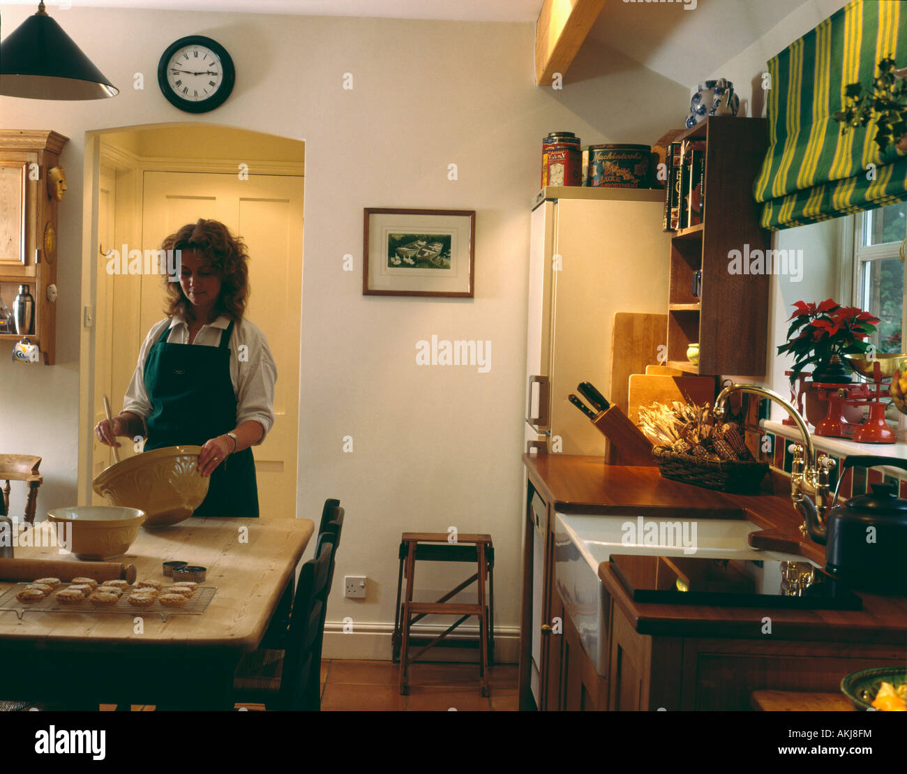 Woman stirring cake mixture in country kitchen Stock Photo - Alamy